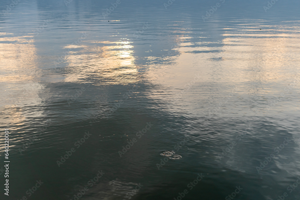 Beautiful calm water reflection of mountains and sunset on a lake ...