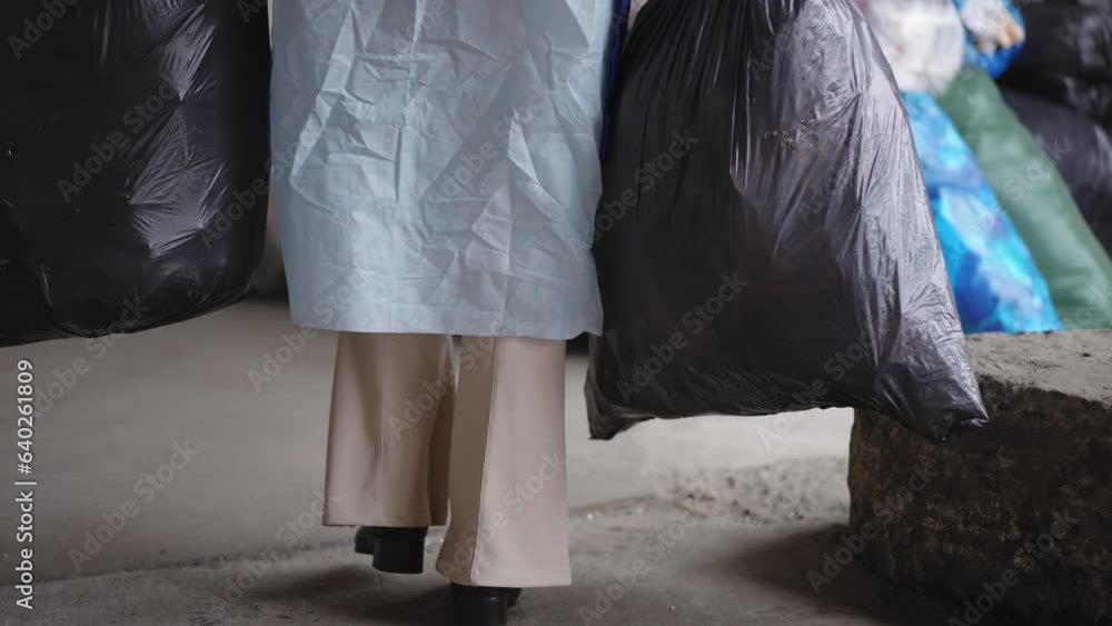 Unrecognizable female volunteer placing garbage bags sorting trash on ...