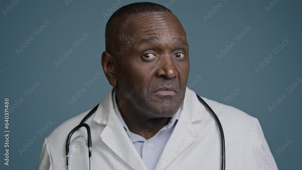 Close-up unsure confused ethnic african american man doctor surgeon in ...