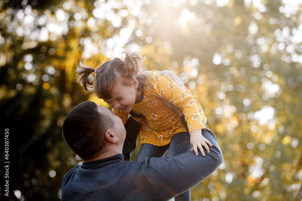 Happy fathers day. Joyful dad throws up his little smiling daughter at ...