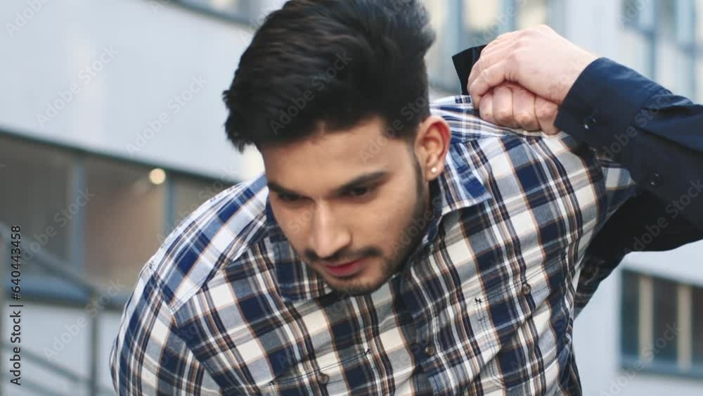 Police officer catch and put suspect under arrest. Cop aiming gun and ...
