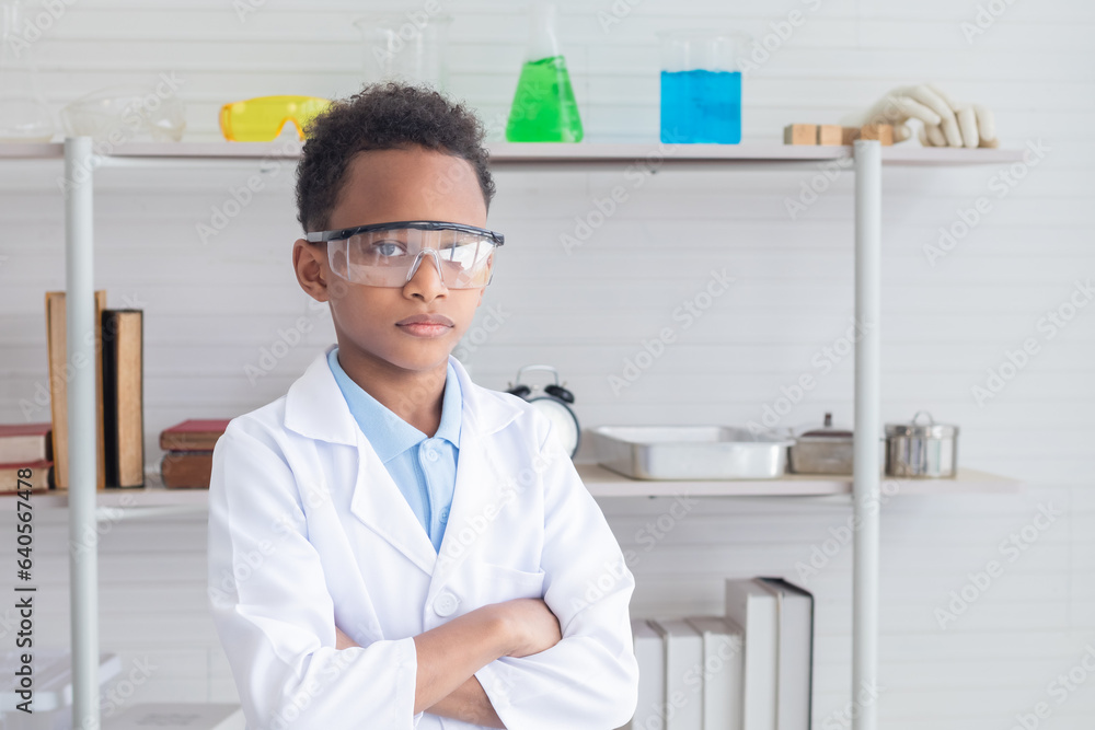 Portrait of African student in lab coat uniform arm crossed wearing ...