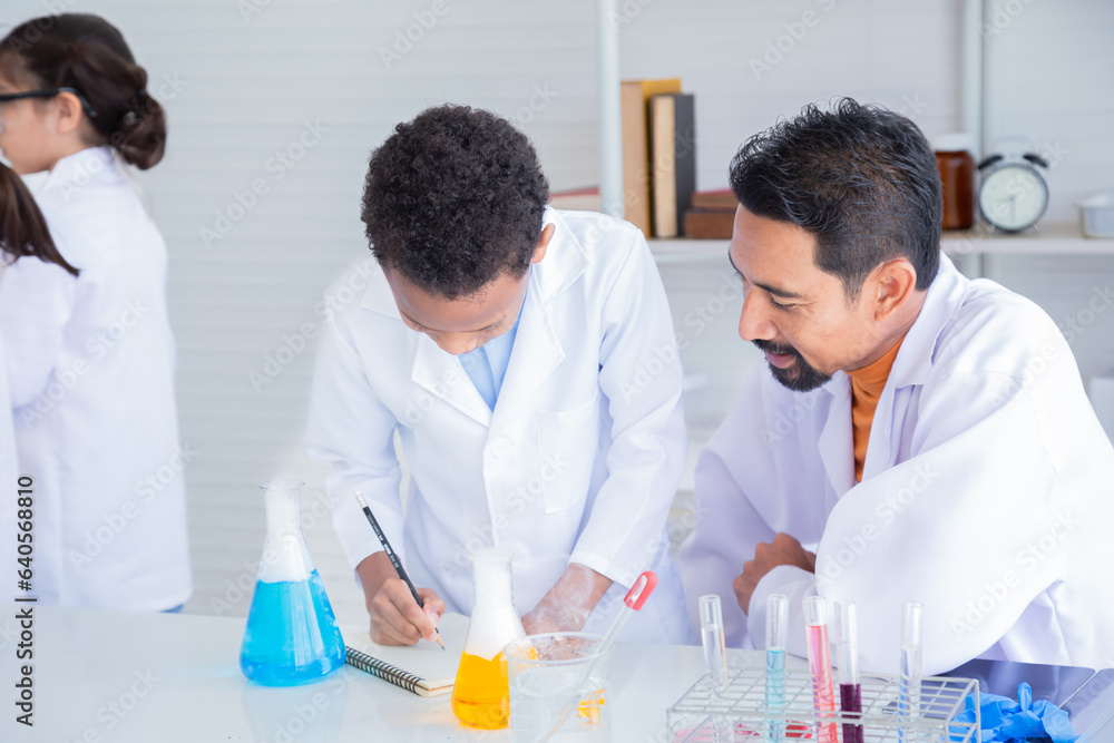 Group of Multicultural primary school students wearing lab coats ...