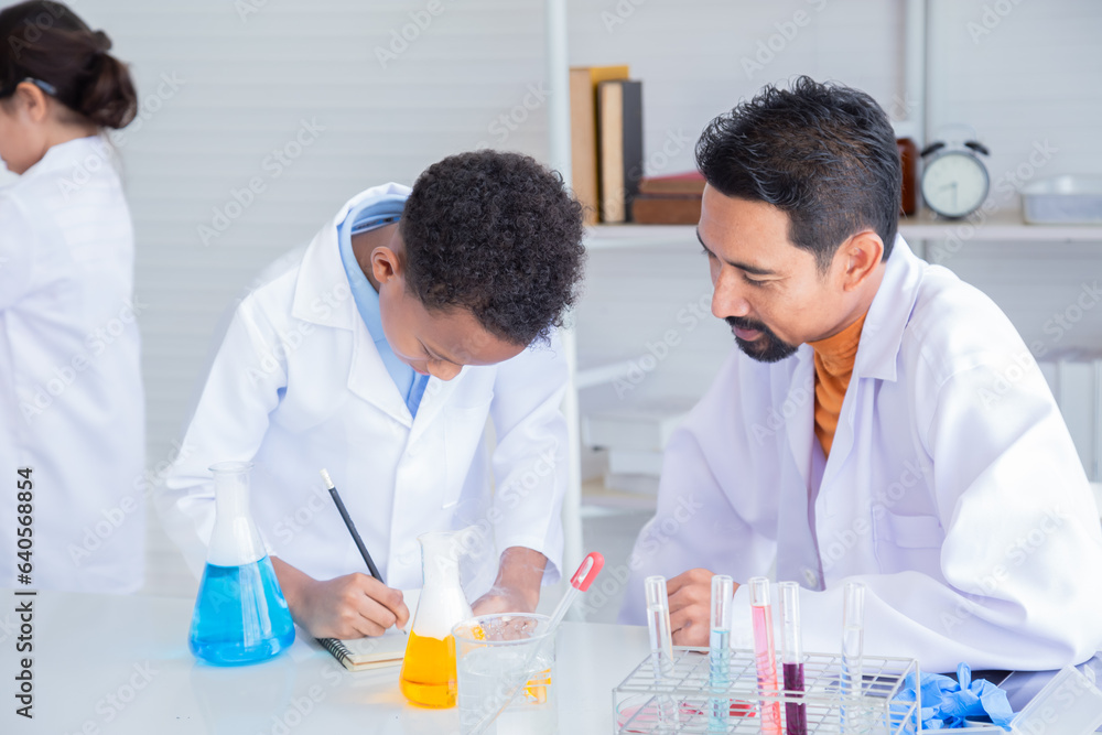 Group of Multicultural primary school students wearing lab coats ...
