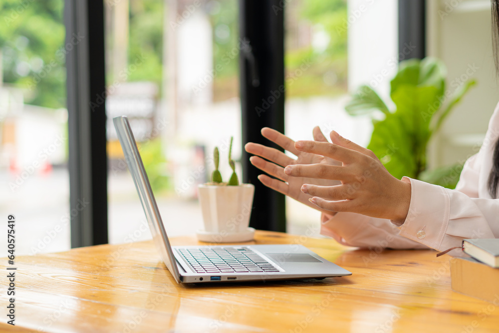 Side view of business woman's hands using laptop computer resting ...