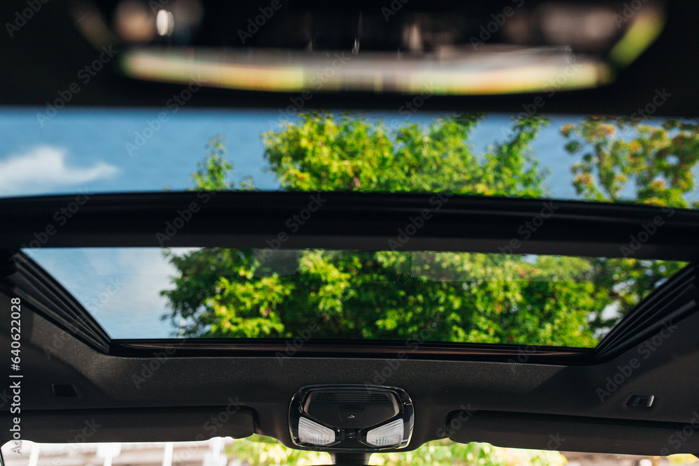Panoramic sunroof at the car and blue sky. Clean sunroof and view of ...