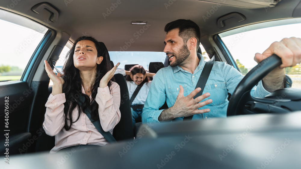 Family having quarrel in car, husband shouting at wife while driving ...