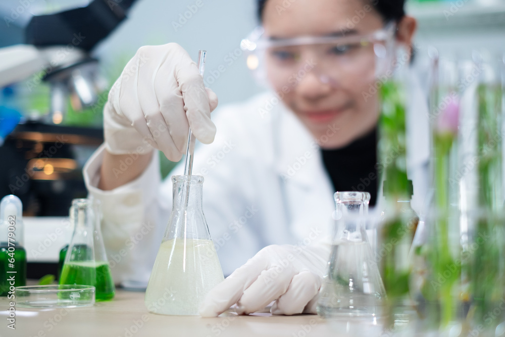 Scientist is focusing and stirring liquid or substance sample in plant ...