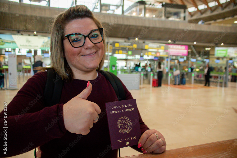 Thumbs up of an Italian female passenger showing her passport at the ...