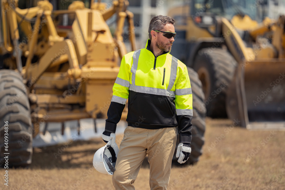 Machinery builder at buildings background. Excavator loader tractor and ...