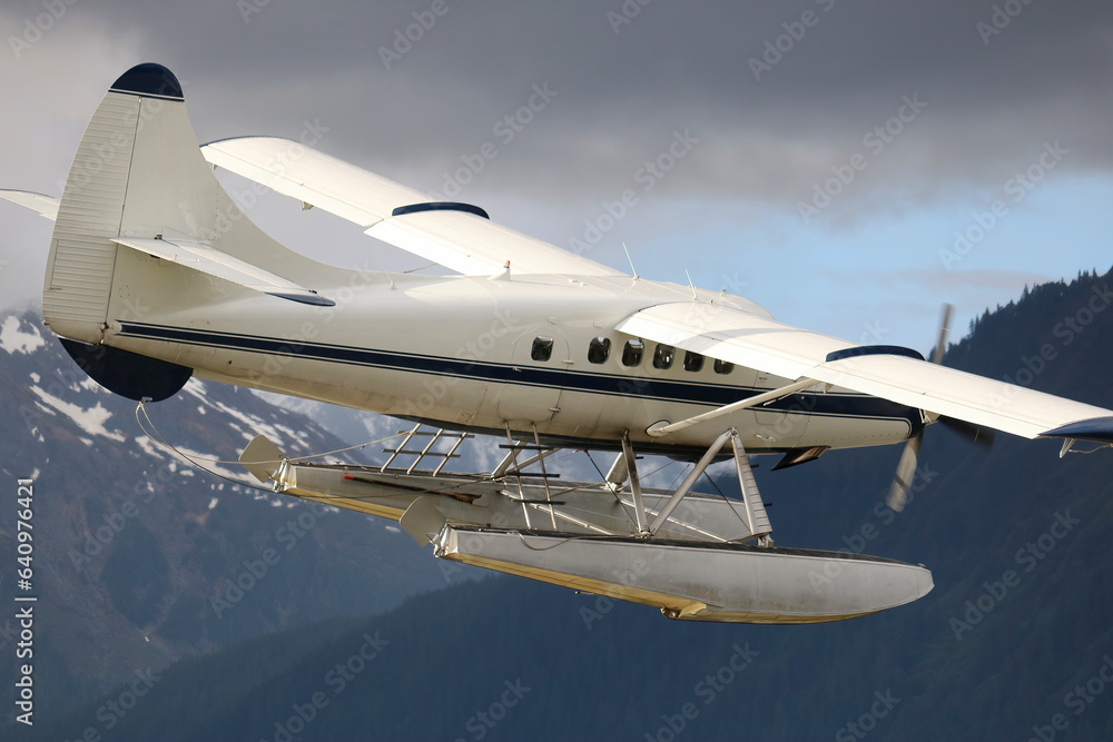 Alaskan Bush Plane - A generic, unmarked seaplane aircraft approaches ...