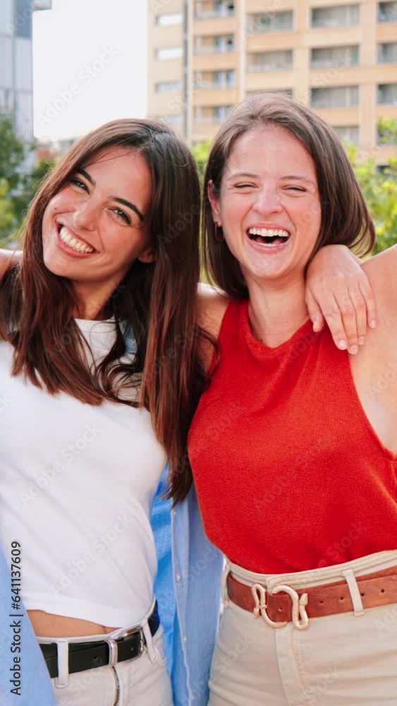 Vertical portrait of two happy student girls having fun excited to ...