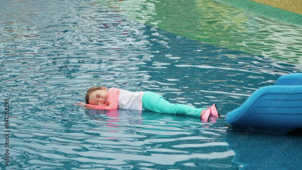Happy Little Toddler in Swimsuit Refreshing Lying in Shallow Water ...