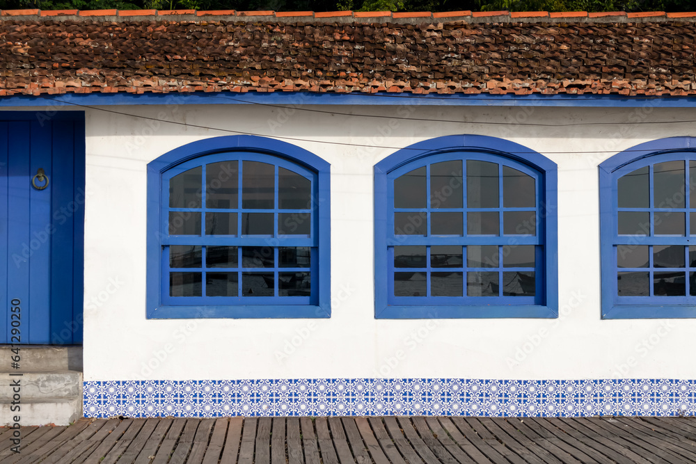 House with arched windows, in blue wood, white wall with Portuguese ...