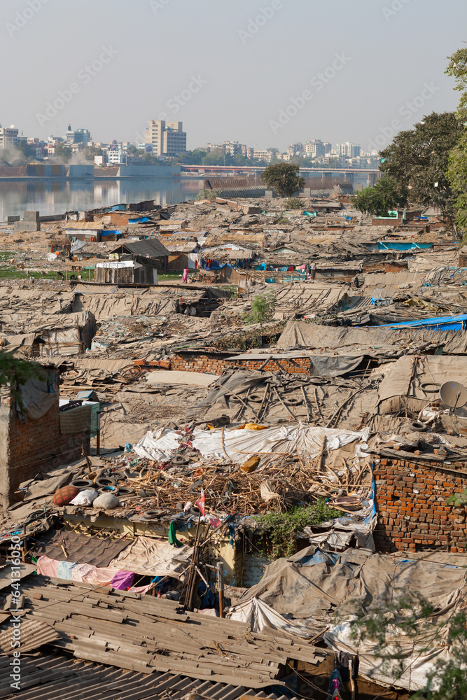 Slums in the foreground and modern high-rises buildings across the ...