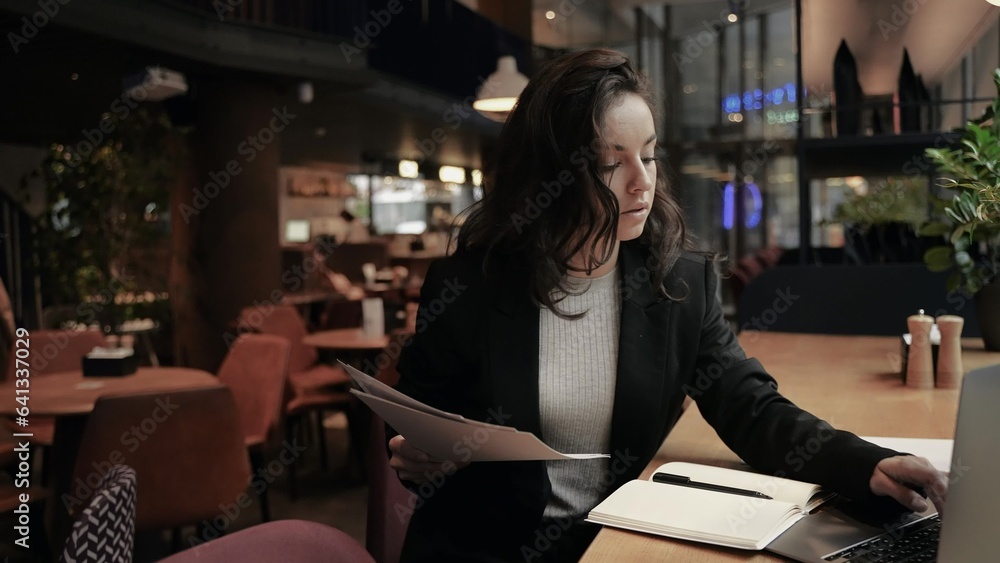 Woman works as an accountant she is calculating budgets. Caucasian ...