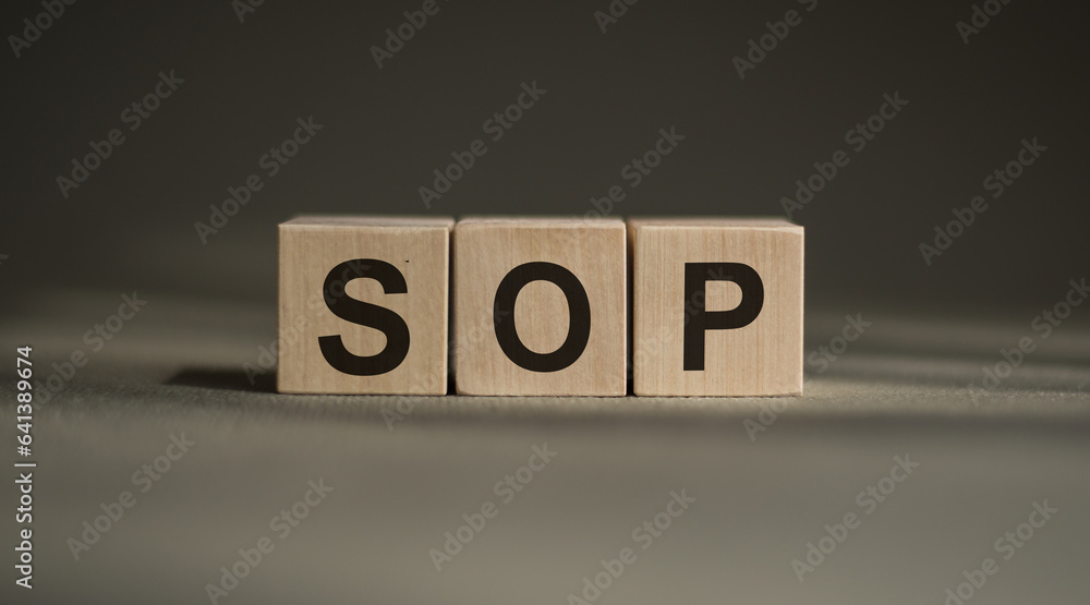 Letters of the alphabet of SOP on wooden cubes, gray shadows background ...