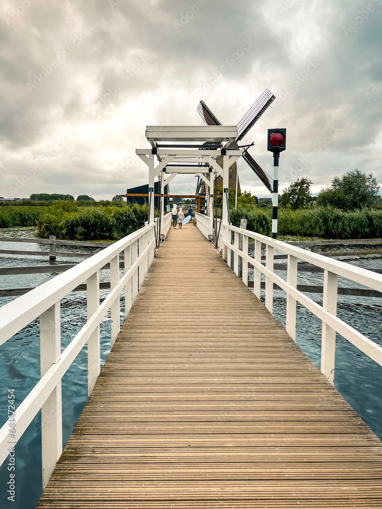 Covered footbridge over the Dutch canal system in Kinderdijk ...