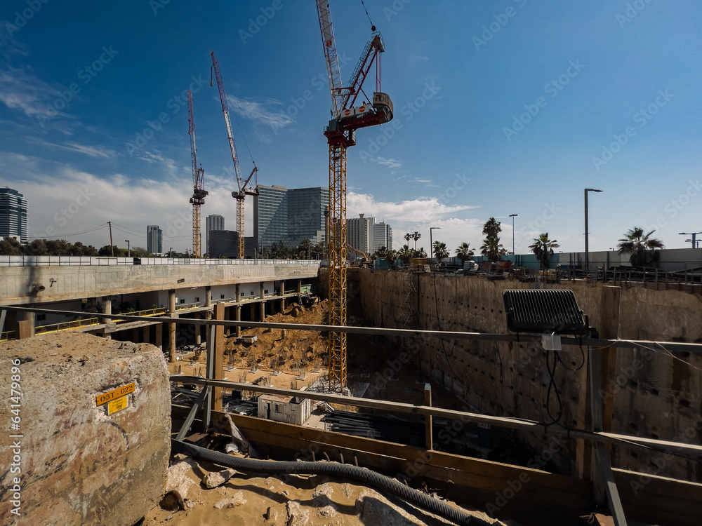 At a construction site for a new skyscraper, a massive pit has been dug ...