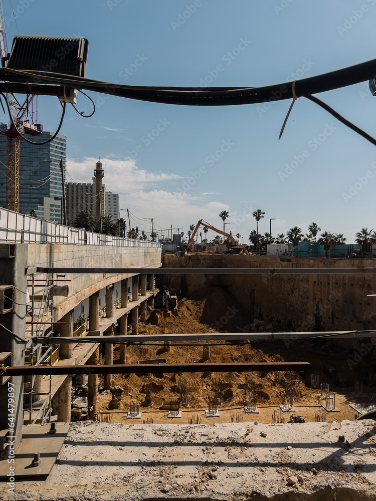 At a construction site for a new skyscraper, a massive pit has been dug ...
