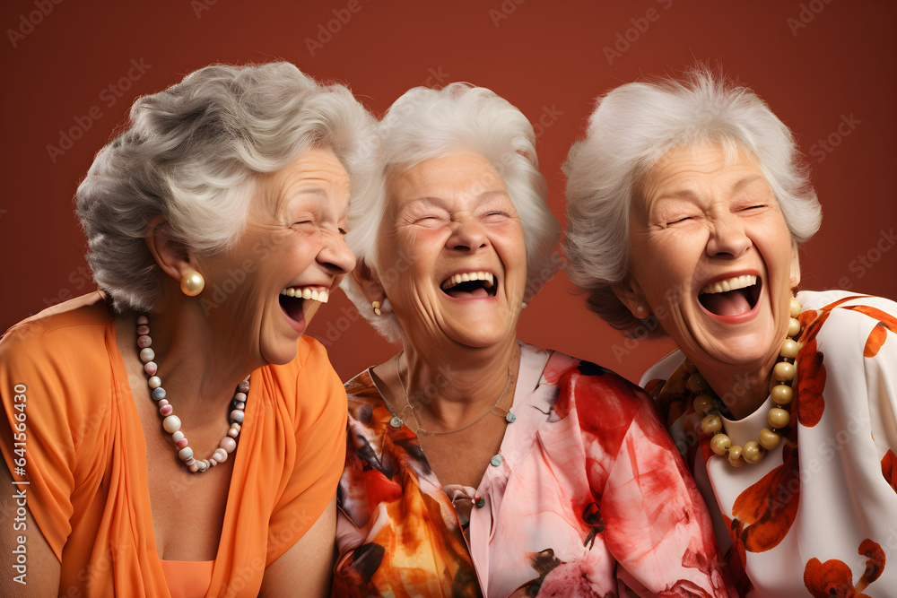 studio portrait of three old ladies, friends laughing together, plain ...