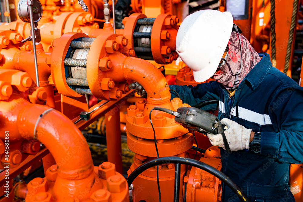 Non-destructive testing technicians are checking the thickness of elbow ...