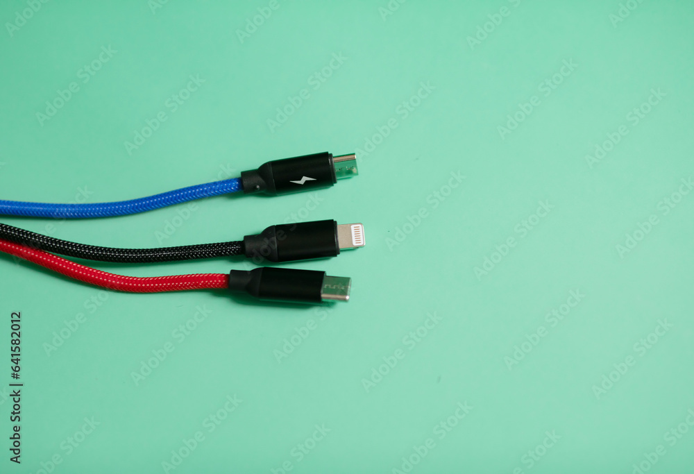 Folded USB lightning cable isolated over the green background. Three ...
