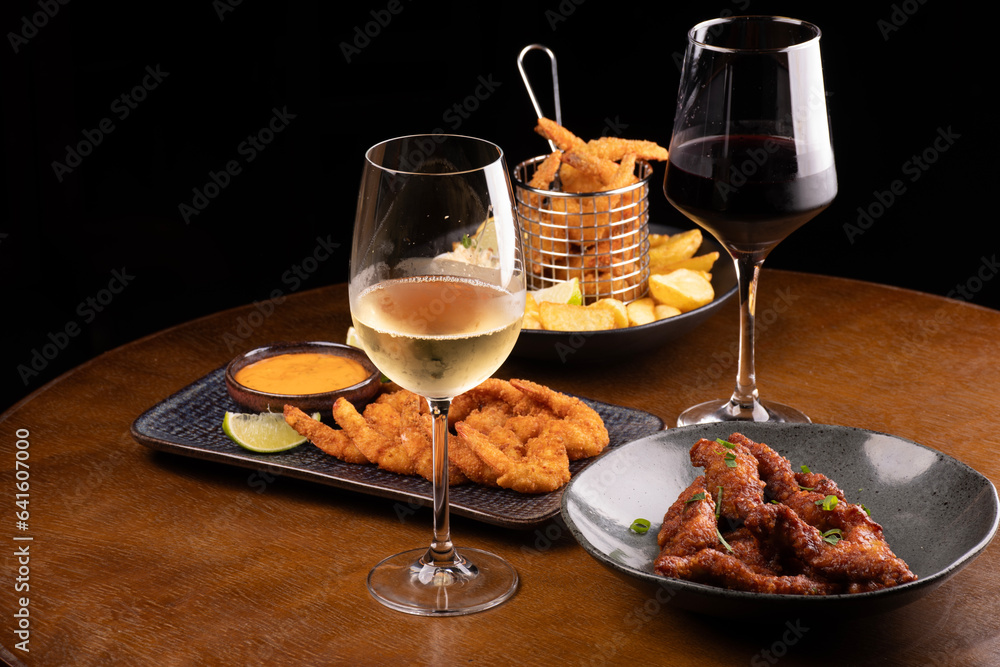 happy hour table in pub with two glasses of white and red wine and ...