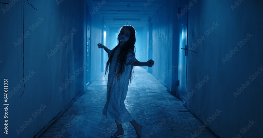 Little girl in white dress looking like a ghost carelessly dancing in ...