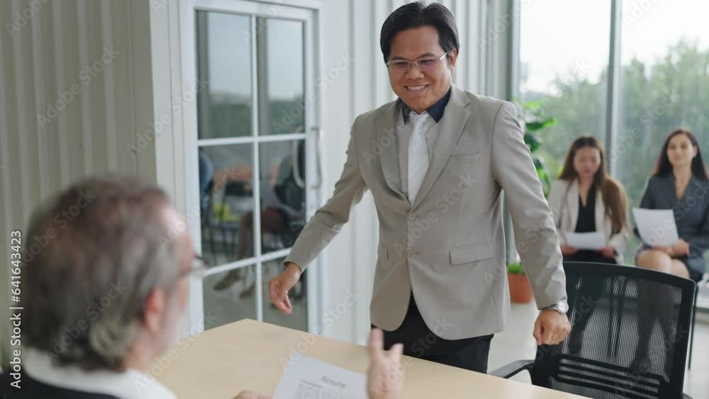 Asian candidate man giving resume having shaking hands with team of ...