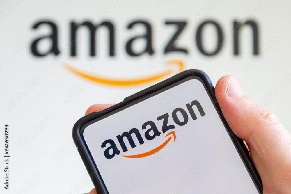 Hand holding a mobile phone with Amazon logo online marketplace ...