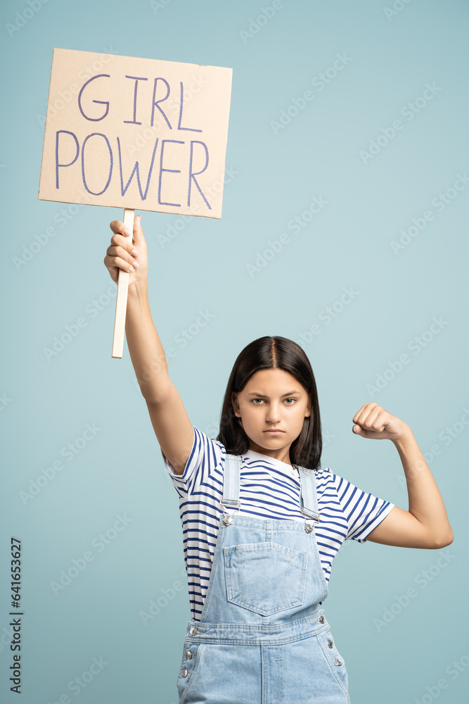 Confident strong brunette teenager girl with long hair showing power ...