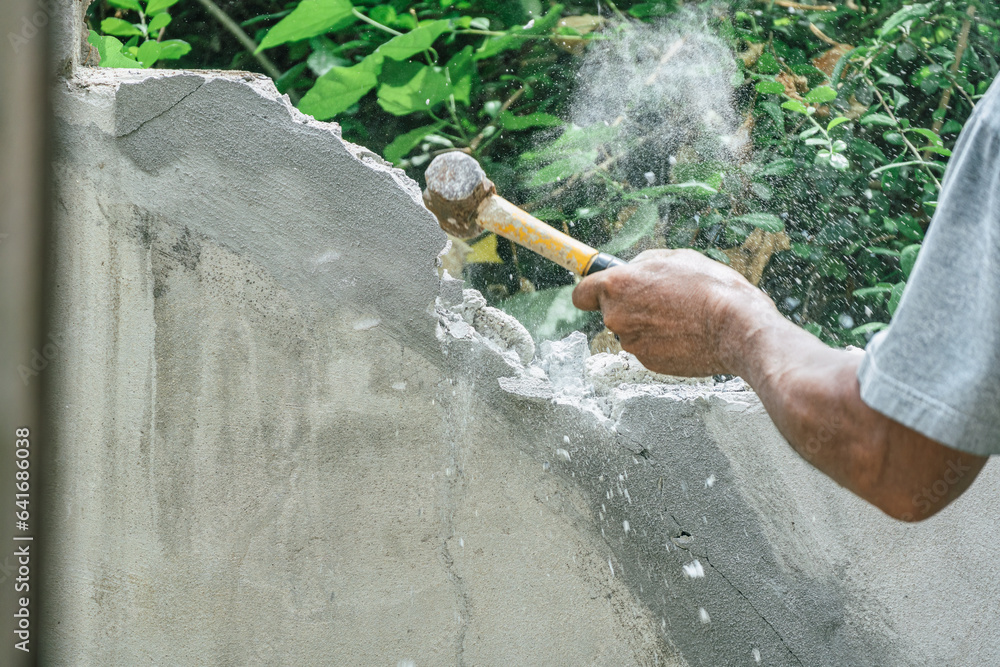 Hand of worker using hammer smashing and demolish on brick wall at ...
