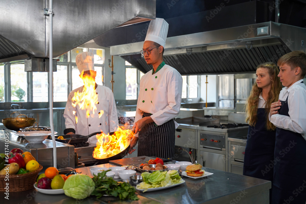 Chef teacher teaches cooking to the group children in class kitchen ...