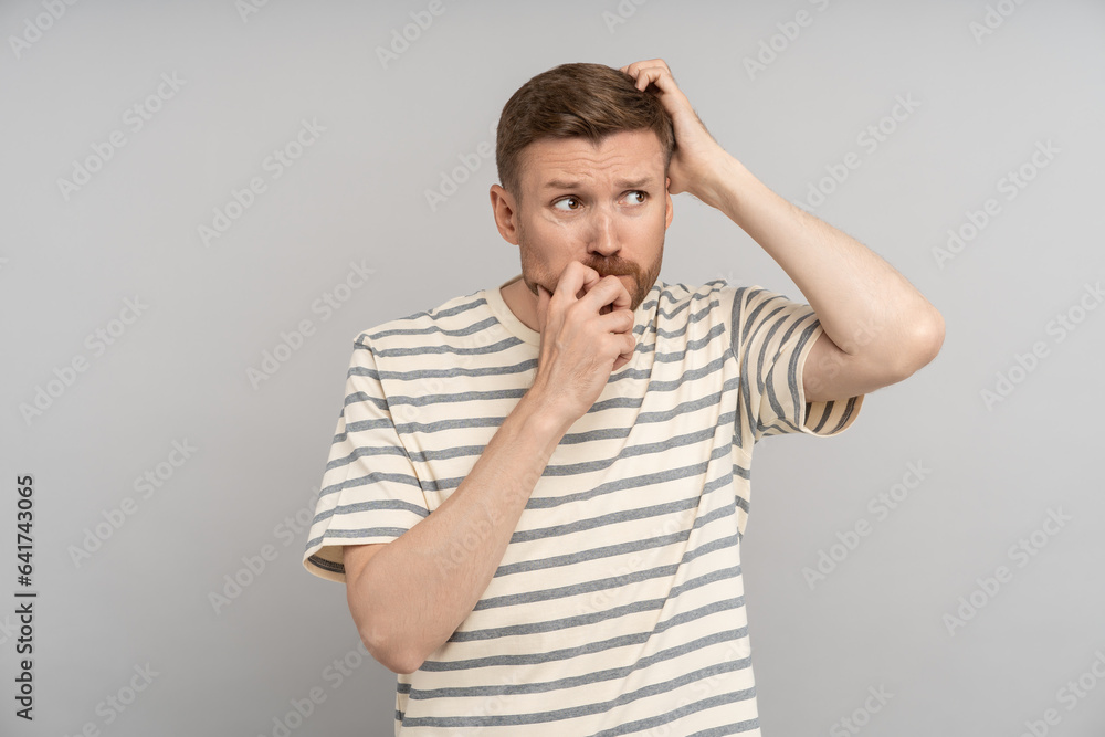 Nervous guy with mental health disorder in difficult thought scratches ...