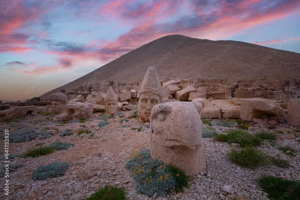 The ancient carved heads of Zeus, Apollo, Hercules and lion at sunset ...