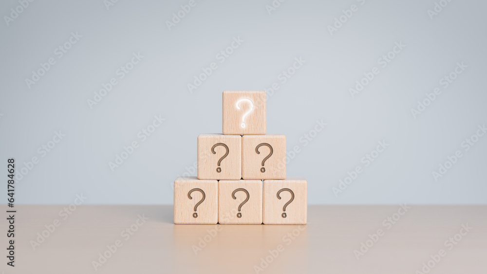 Stacked wooden cube blocks with question mark icons. Brainstorming ...