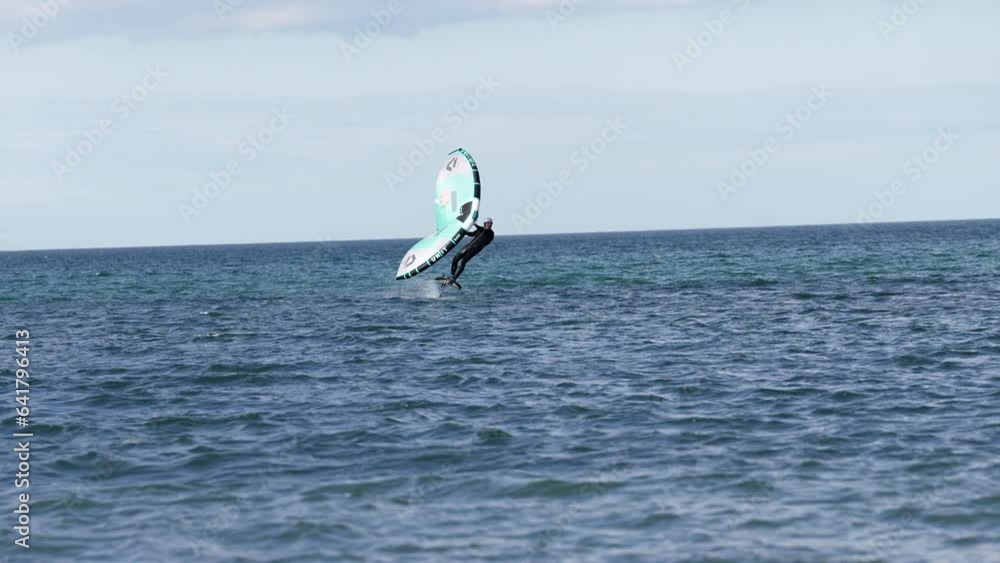 Modern water sport. Hydrofoil ride on the ocean using the wing and the ...