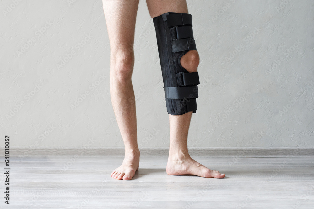 Knee support brace on a male leg. Man in an orthosis. Orthopedic ...
