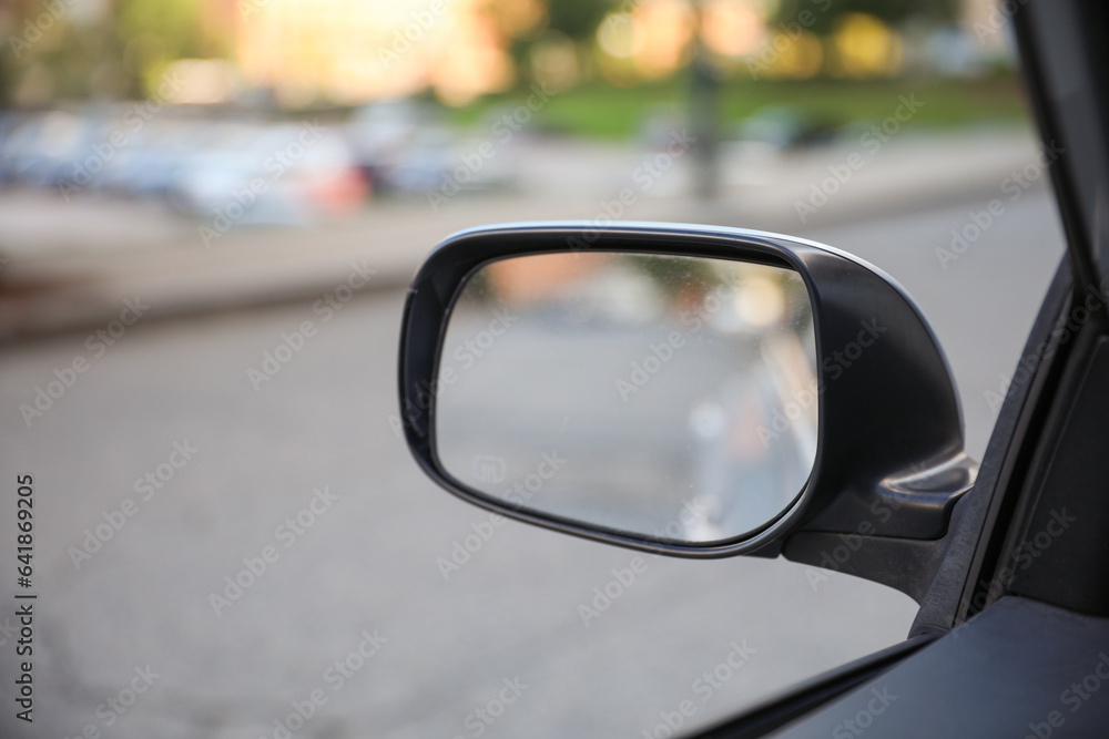 Car mirror reflects paths behind, a symbol of retrospection, foresight ...
