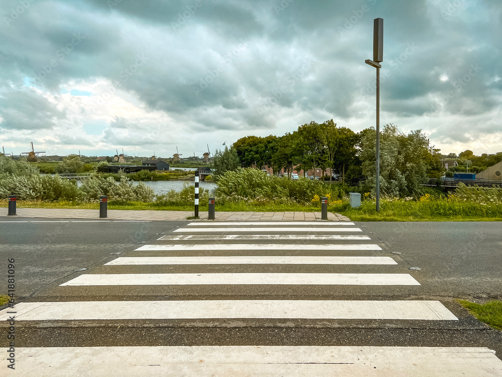 Street Crossing that Leads to the Iconic Dutch Windmills and canal ...