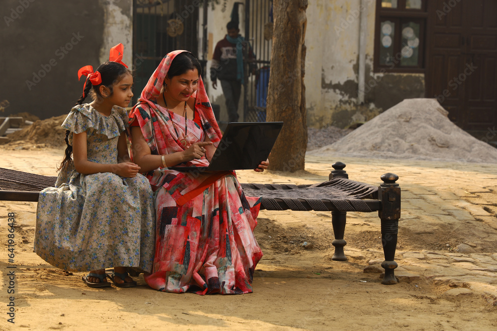 Happy Indian Rural family in village. mother wearing a traditional ...