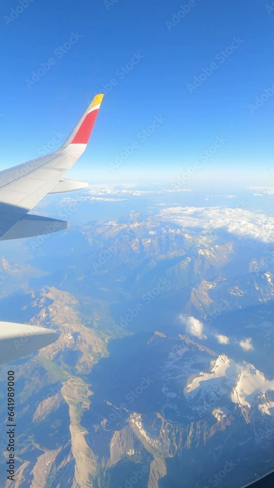 Video Stock Flying over the Swiss Alps from the window of an airplane ...