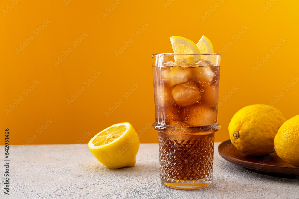 Long Island iced tea cocktail garnished with lemon slice in highball glass. Long Island iced tea ...