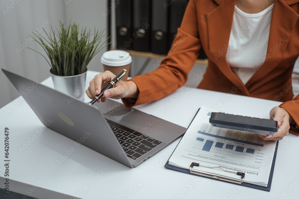 Close up hands of woman in brown formal suit checking bills, taxes ...