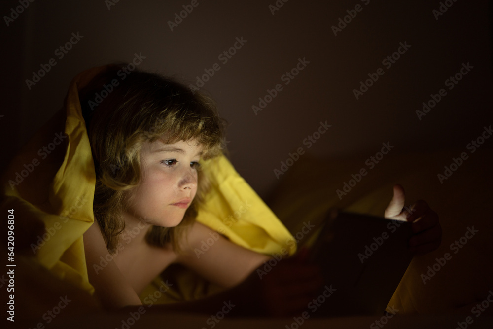 Kid playing on a digital tablet. Kid using tablet for gaming and online ...