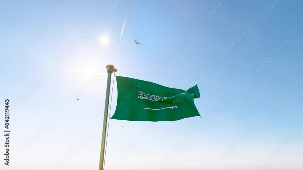 Flag of Saudi Arabia waving in the wind, sky and sun background. Saudi ...