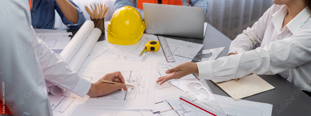 Engineer partner drawing and working on blueprint design together on ...