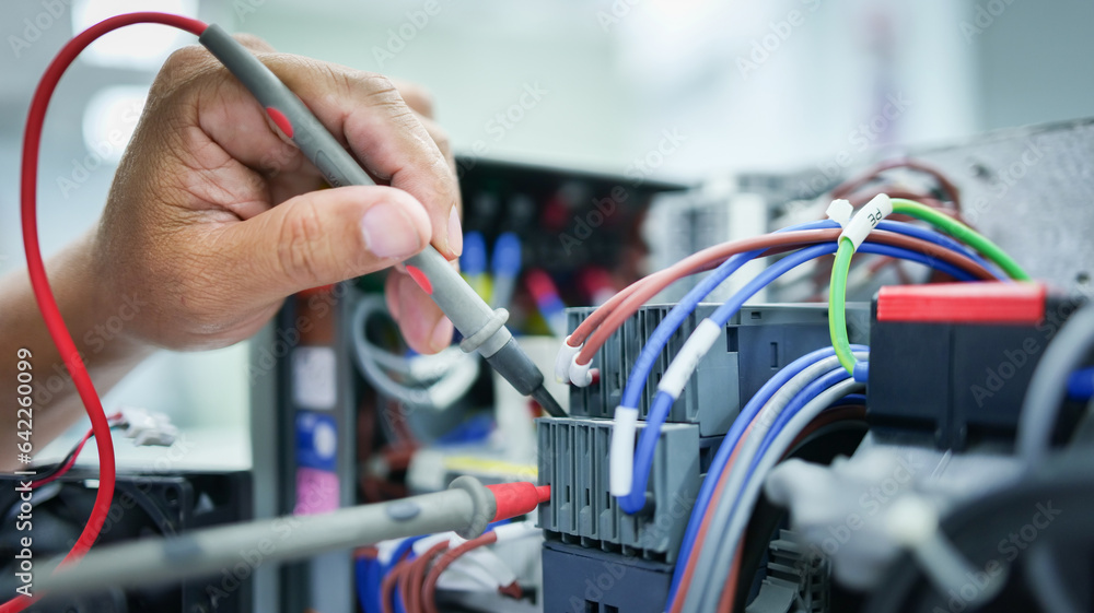 Electrical engineer checking and fixing automatic control switchboard ...