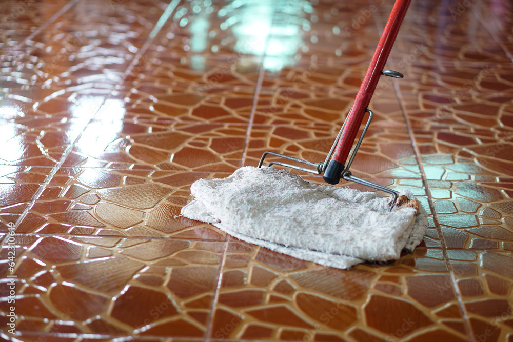 Close up man use a mop by using old towel to mop the floor. Concept ...